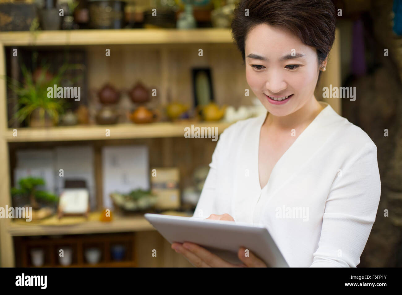 Shopkeeper using digital tablet Stock Photo - Alamy
