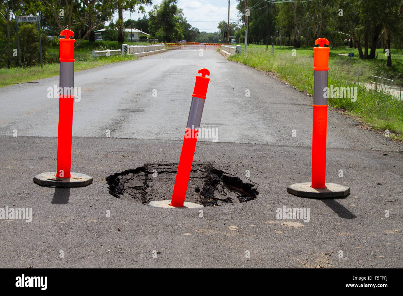 Broken asphalt pavement caused by rain and subsidence due to a lack of ...