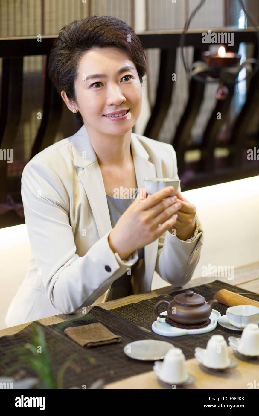 Businesswoman drinking tea in tea room Stock Photo - Alamy