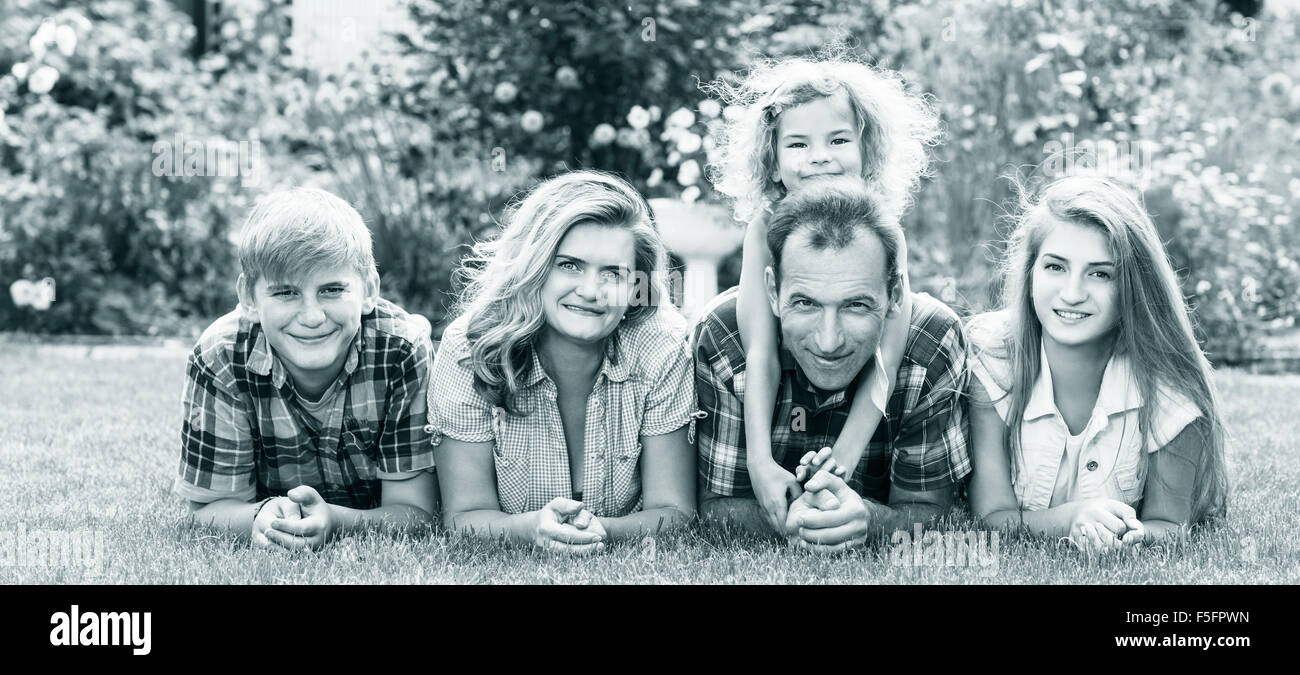 Happy family having weekend in summer park Stock Photo - Alamy