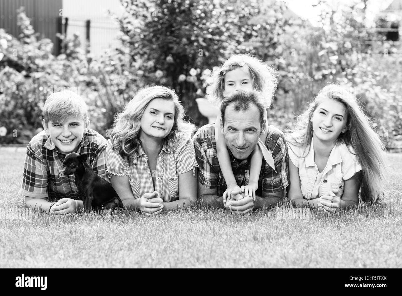 Happy family having weekend in summer park Stock Photo - Alamy
