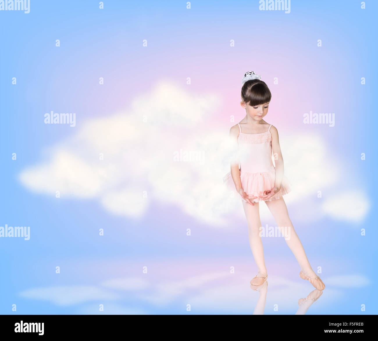 Cute little girl dancing in blue sky with clouds Stock Photo - Alamy