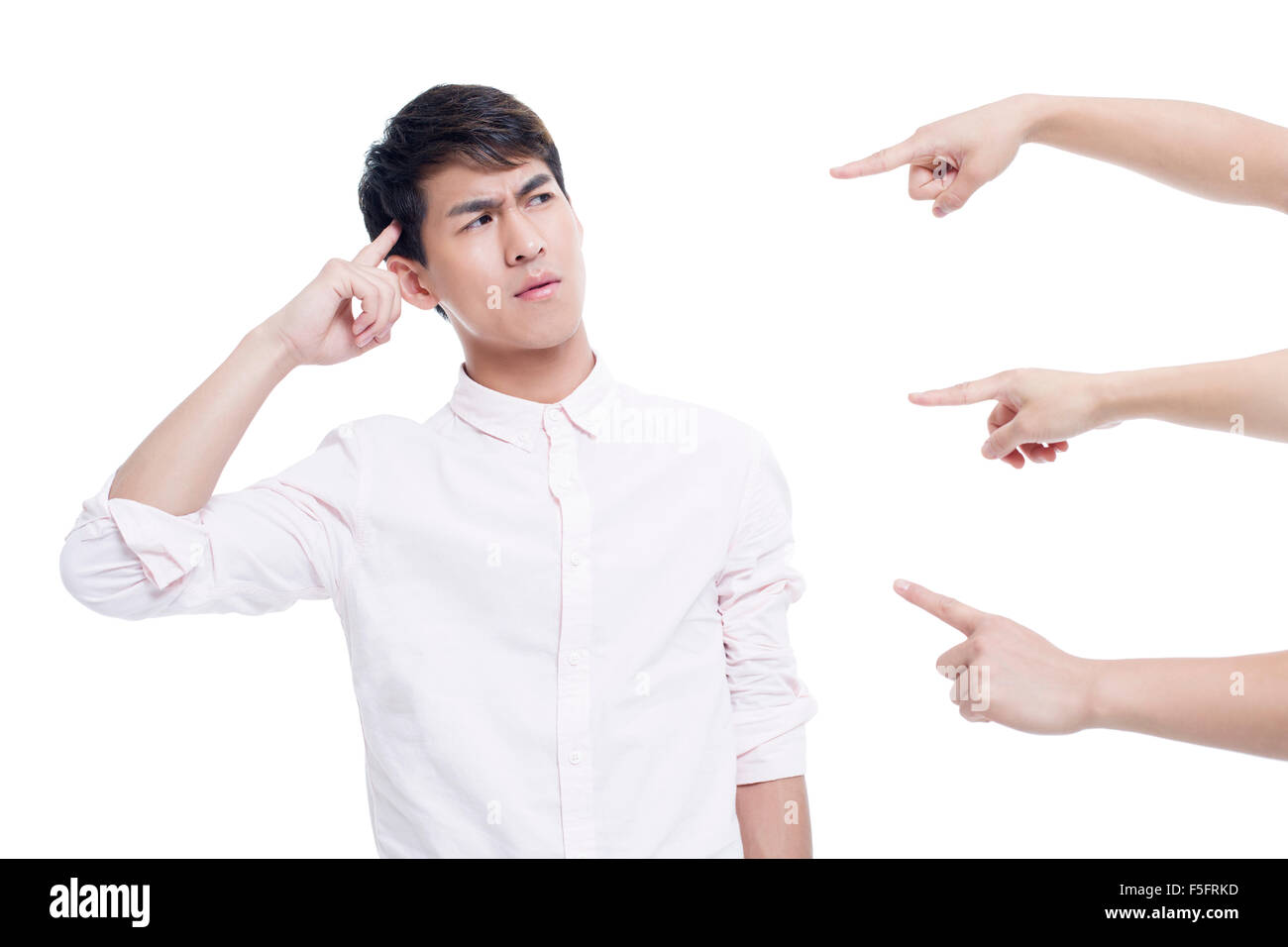 Hands pointing at a young man Stock Photo - Alamy