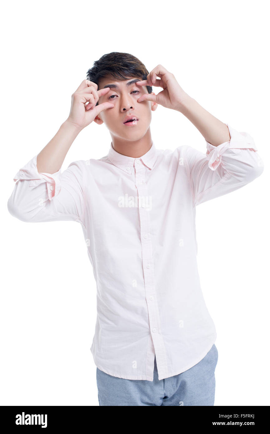 Tired man propping his eyes with hands Stock Photo - Alamy