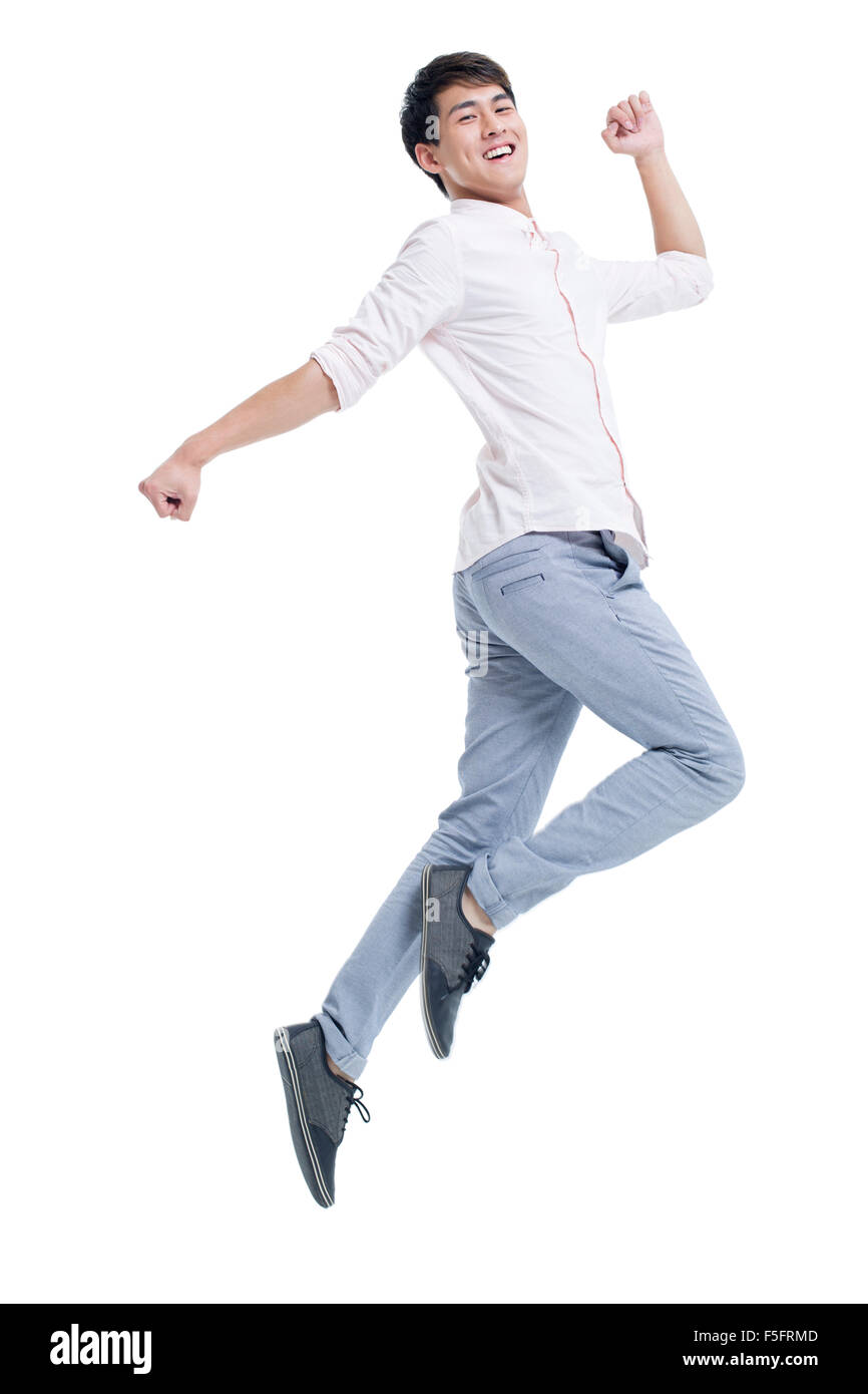 Young man jumping Stock Photo - Alamy