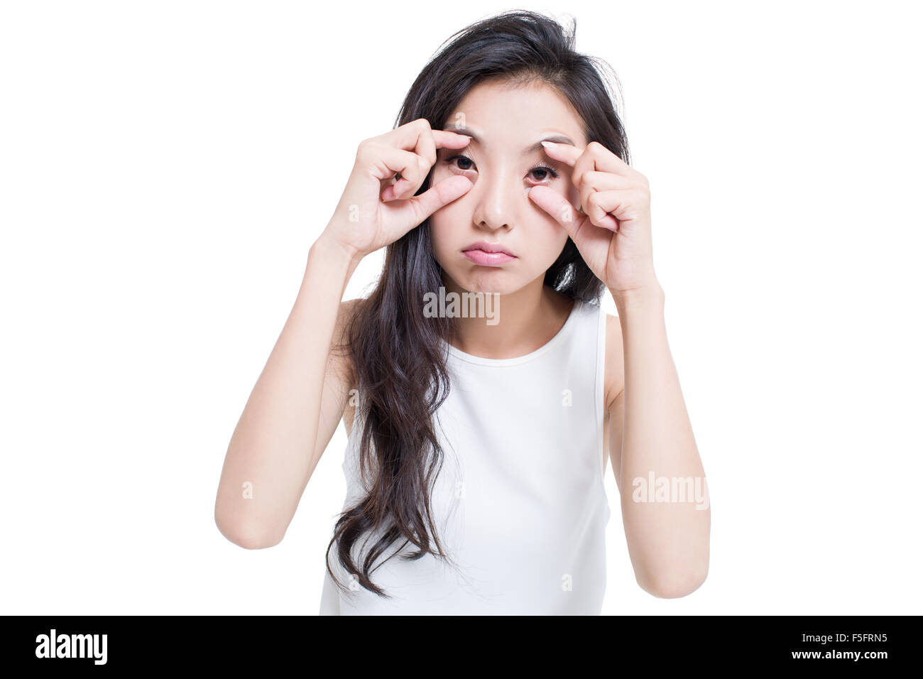 Tired woman propping her eyes with hands Stock Photo - Alamy