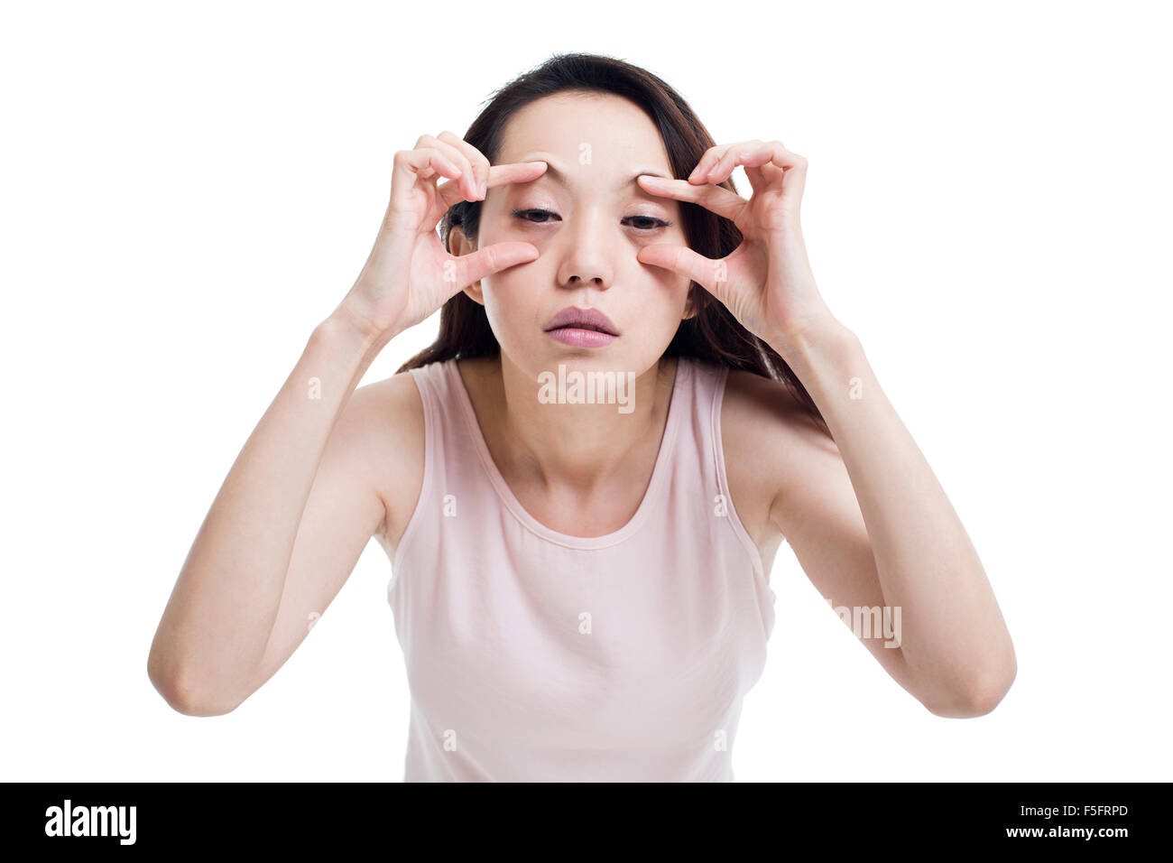 Tired woman propping her eyes with hands Stock Photo - Alamy