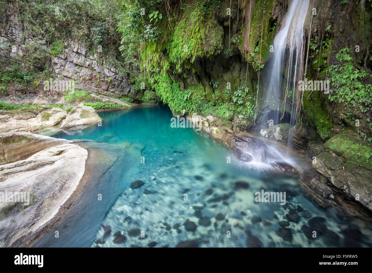 Small waterfalls empties into azure pools of water at the Puente de ...