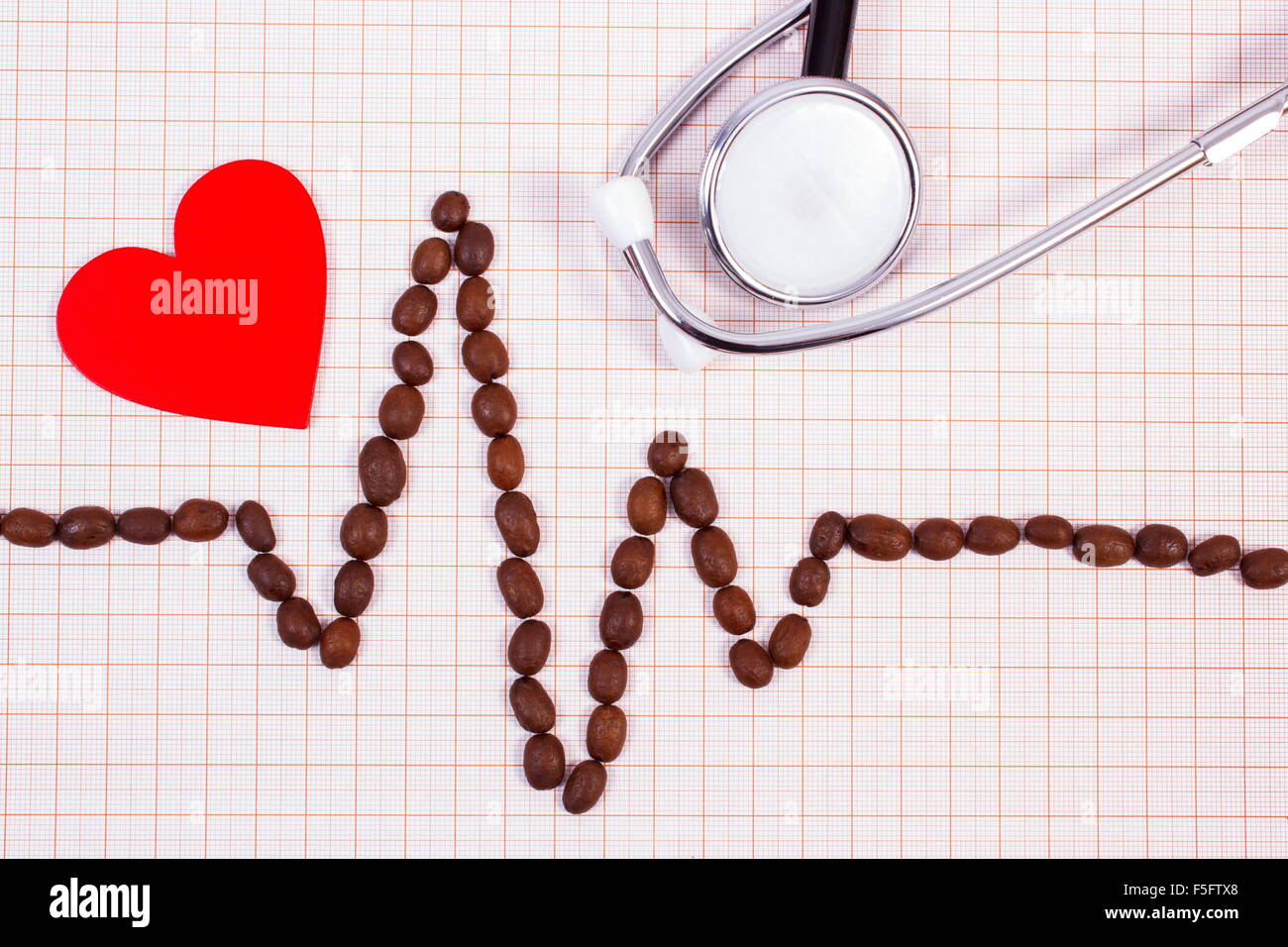 Electrocardiogram line of roasted coffee grains, medical stethoscope ...