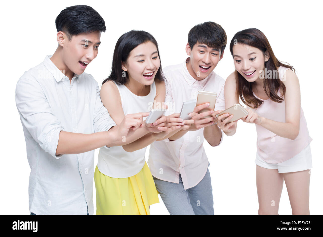 Young adults using smart phones Stock Photo - Alamy