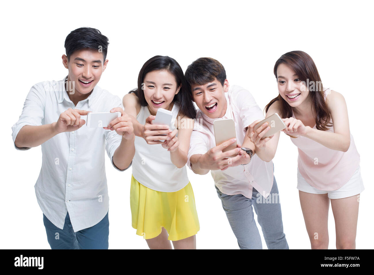 Young adults using smart phones Stock Photo - Alamy