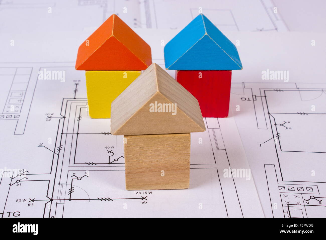Houses shape made of wooden blocks lying on electrical construction ...