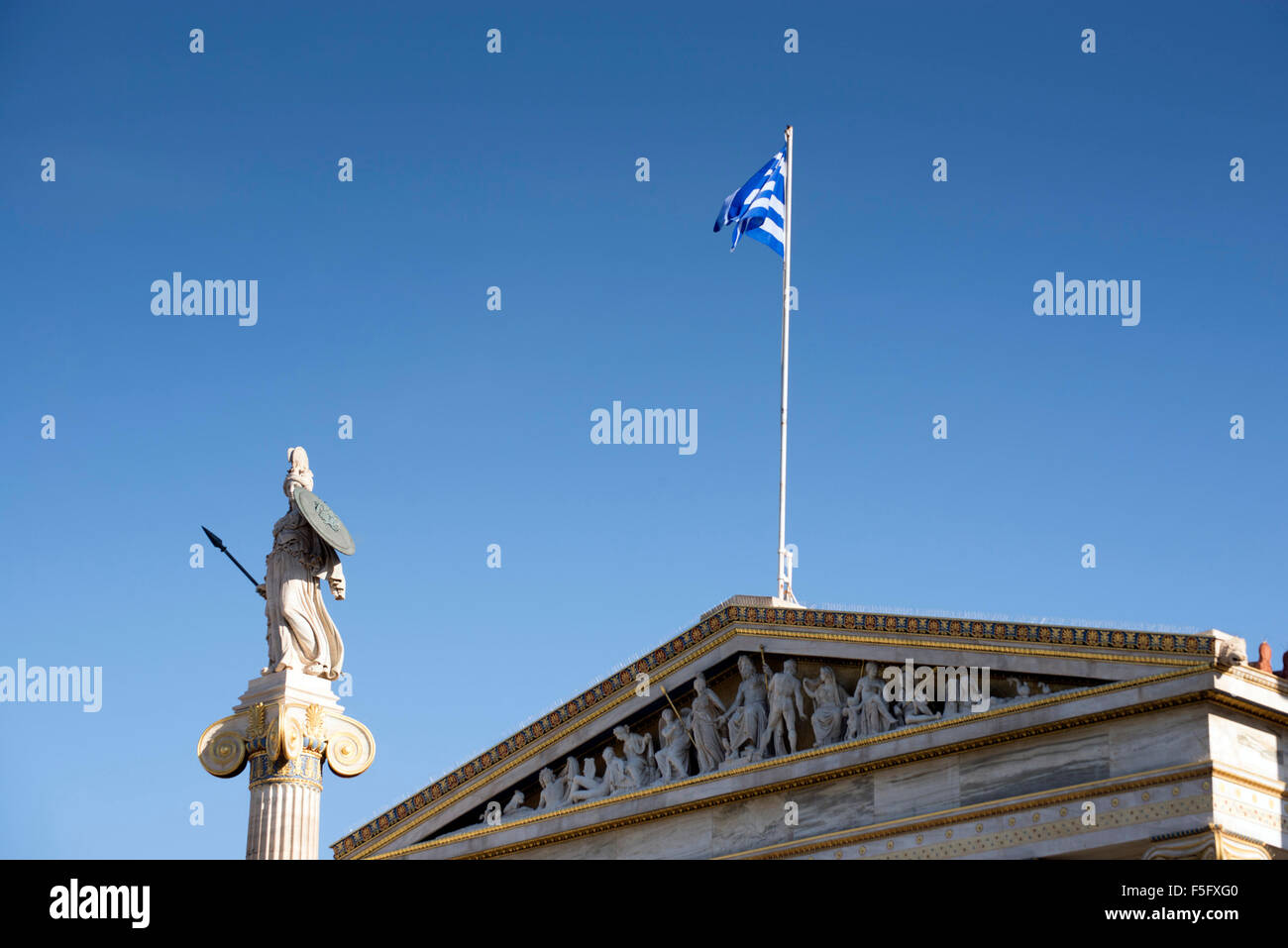Statue of Athena and the Greek flag on the facade of the Academy of ...
