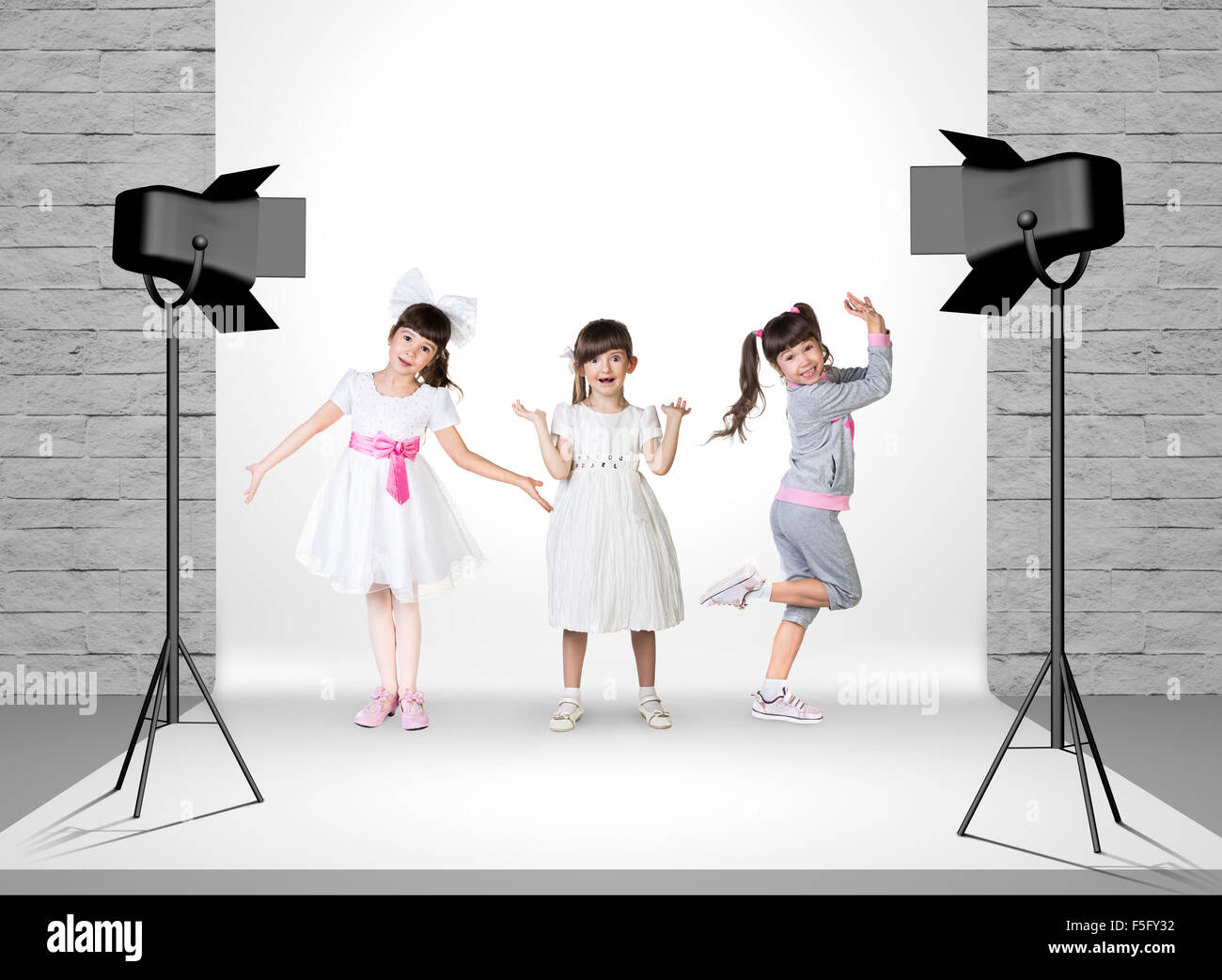 Little girls in photo studio room with white cloth and spotlights Stock ...