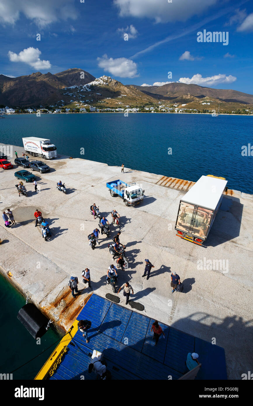 Lorry and passengers getting aboard a ferry in the port of Livadi in ...