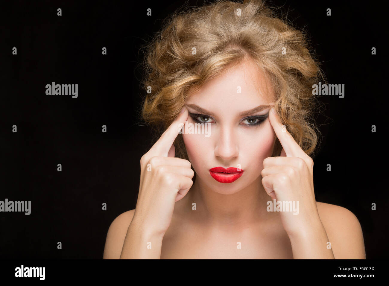 Beautiful woman pointing forehead hi-res stock photography and images ...