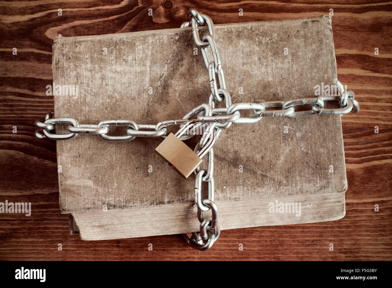 Old book with chain and padlock on wooden table Stock Photo - Alamy