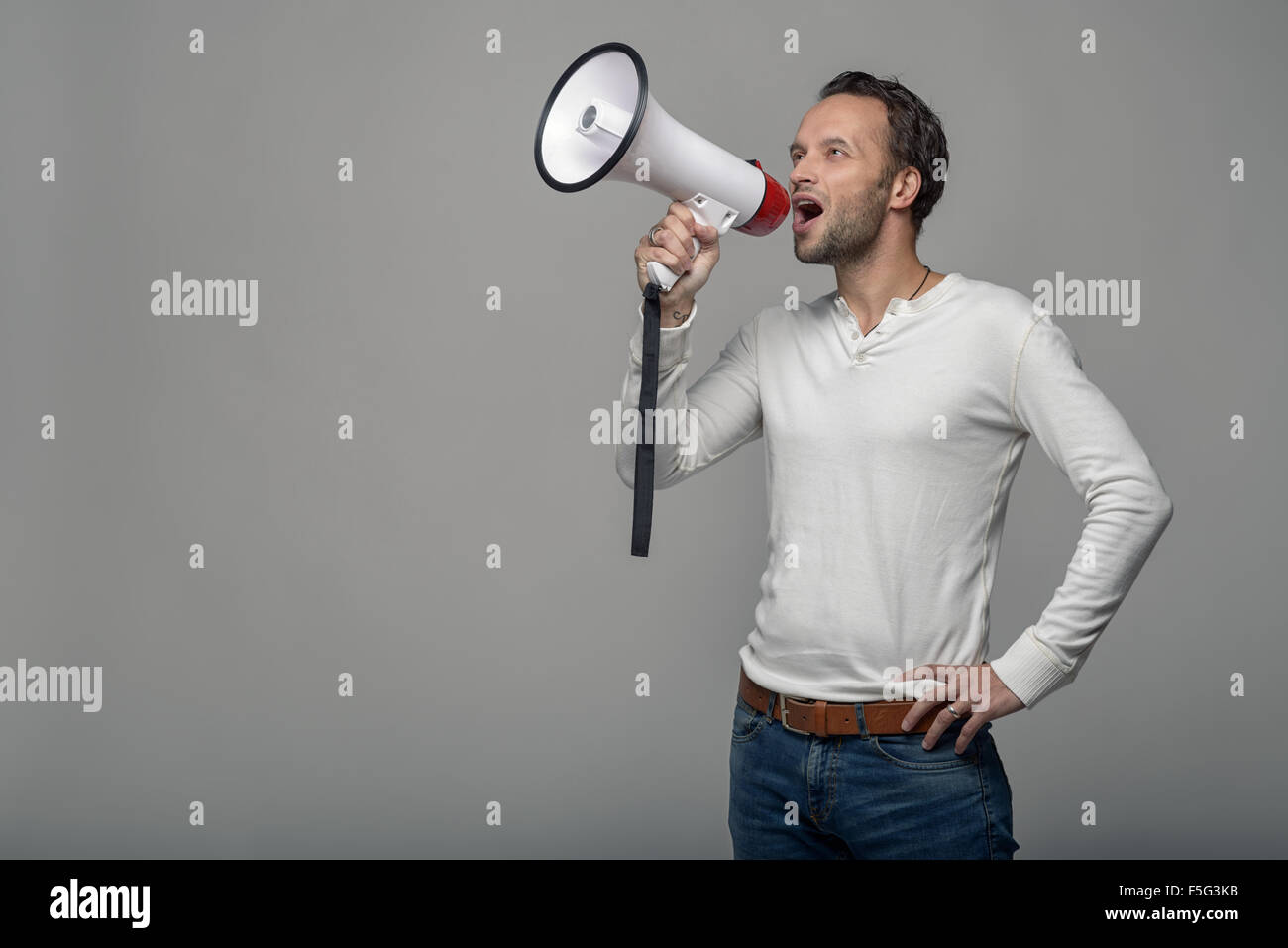 Man speaking over a megaphone as he makes a public address ...