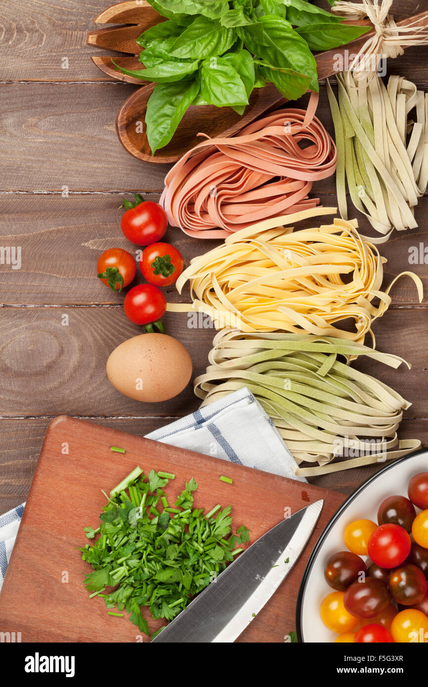 Pasta cooking ingredients and utensils on wooden table. Top view Stock ...