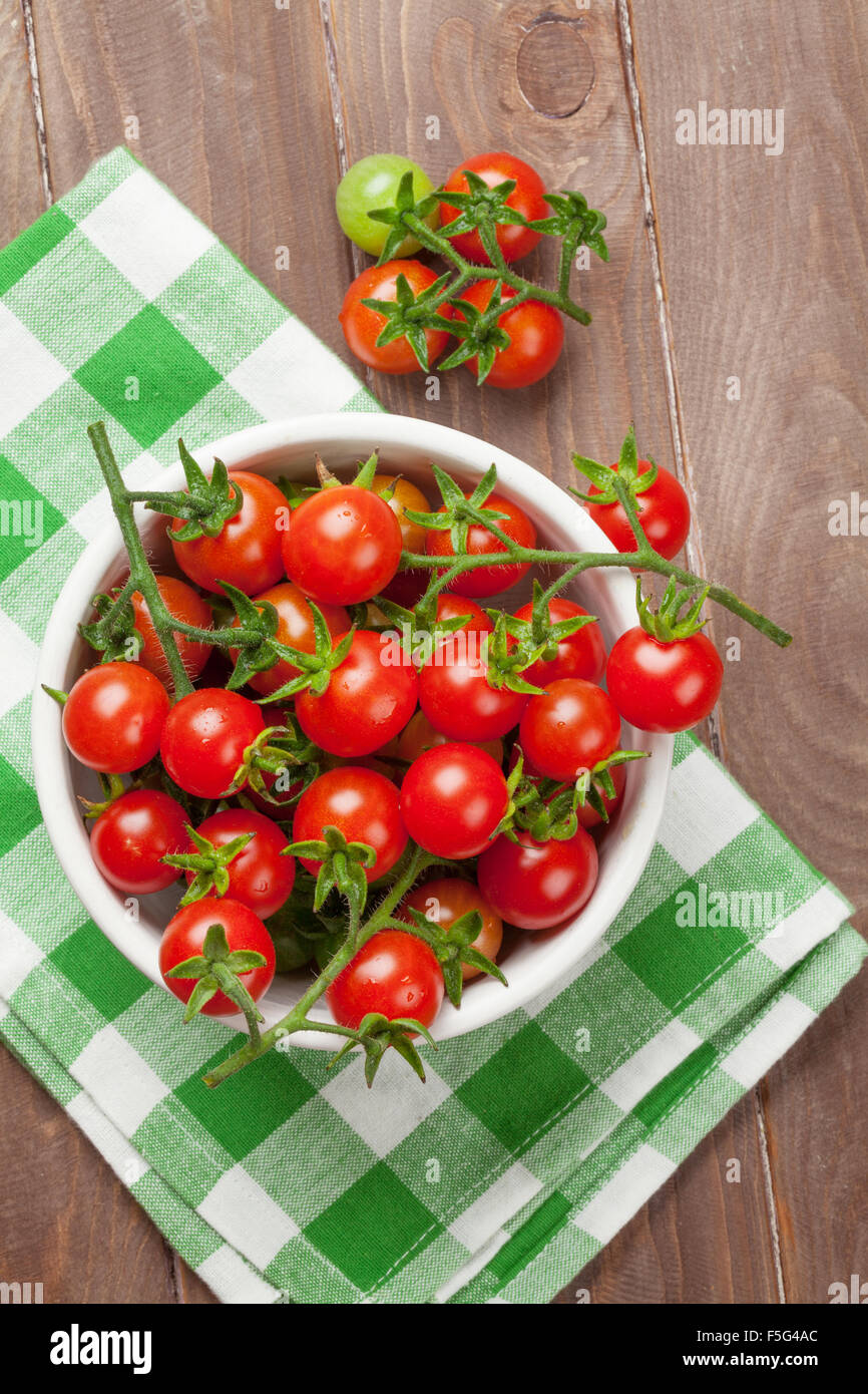 Cherry tomatoes bowl on wooden table Stock Photo - Alamy