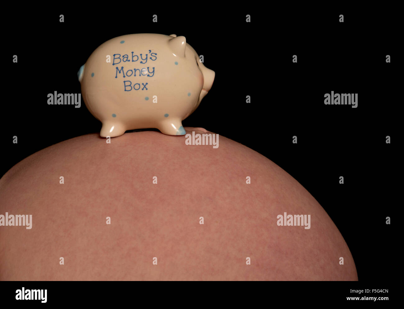 babys money box on pregnant belly cutout Stock Photo - Alamy