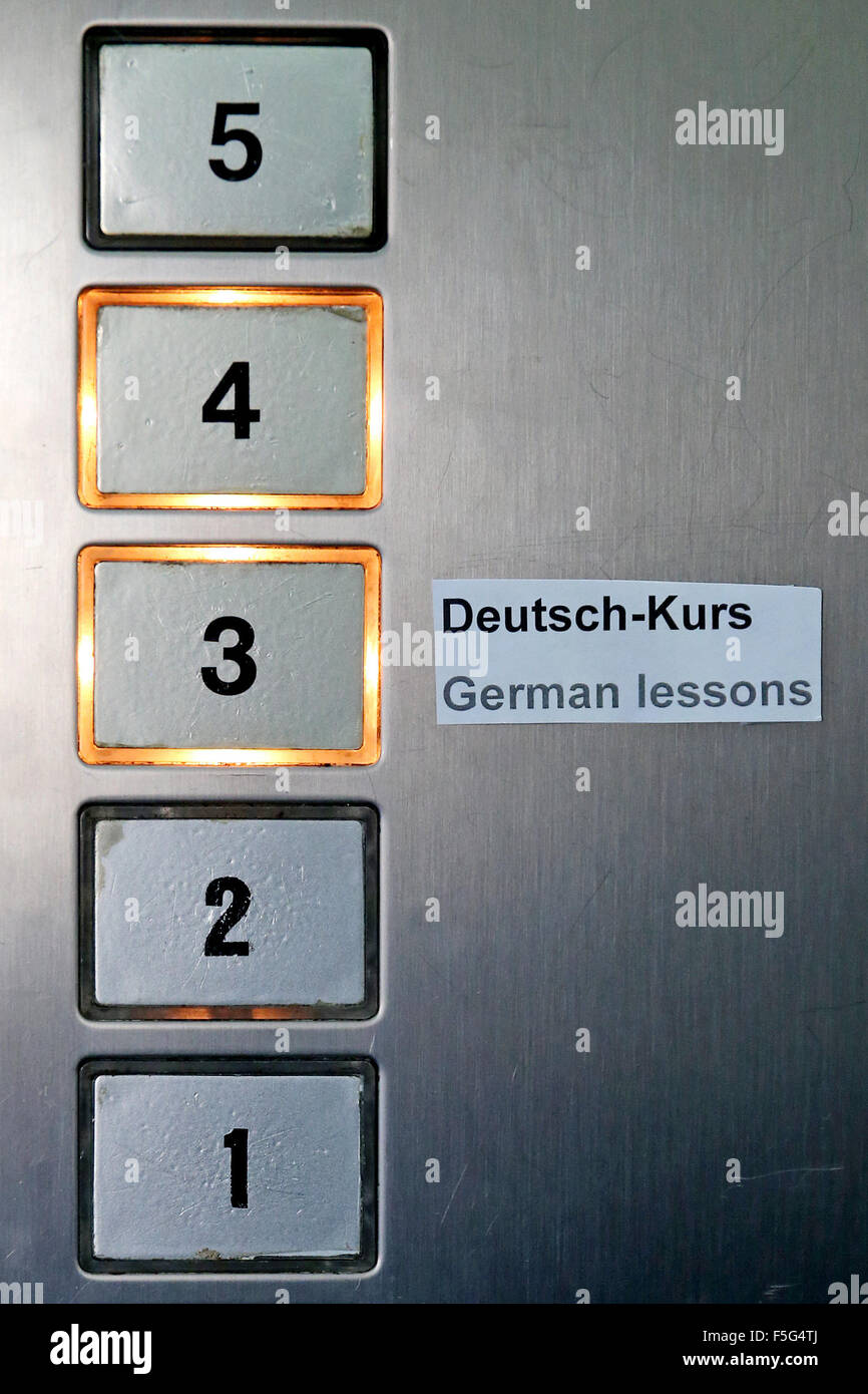 A sign reads '"German lessons' in the elevator of an office building in ...