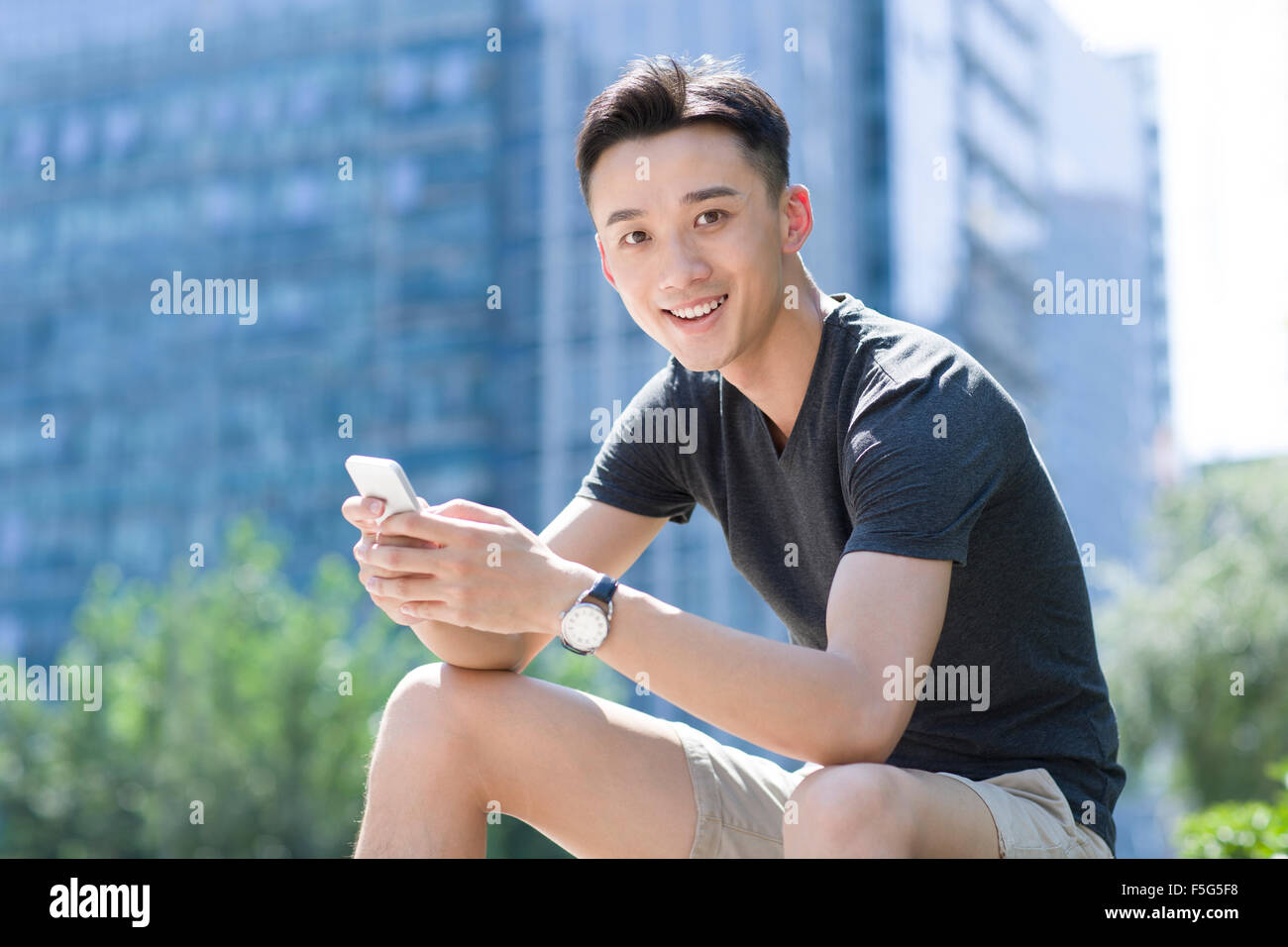 Young man using smart phone Stock Photo - Alamy