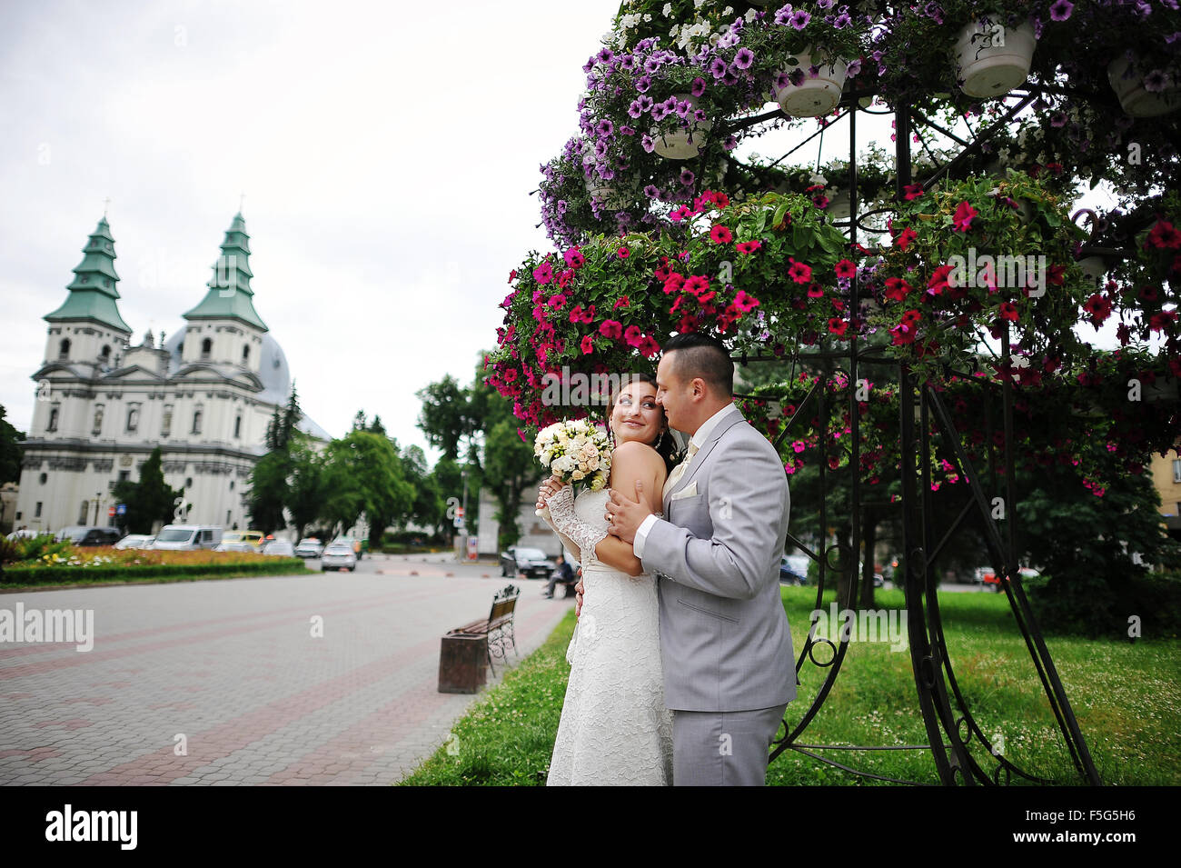 Happy married hugging on background church Stock Photo - Alamy