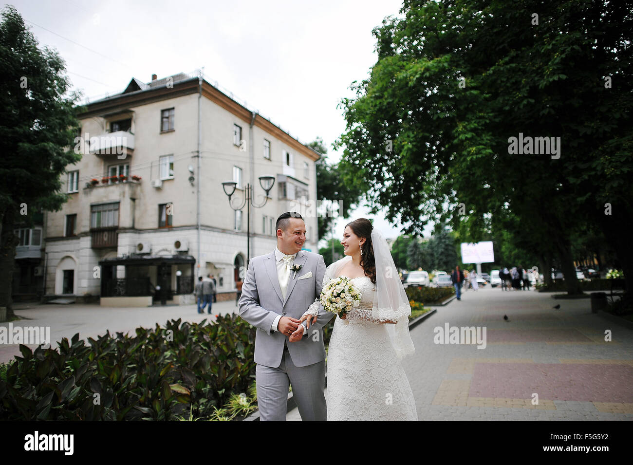 wedding couple walling at the city Stock Photo - Alamy