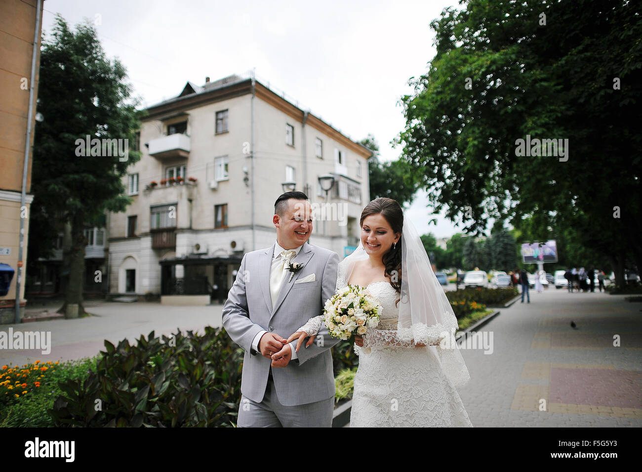wedding couple walling at the city Stock Photo - Alamy