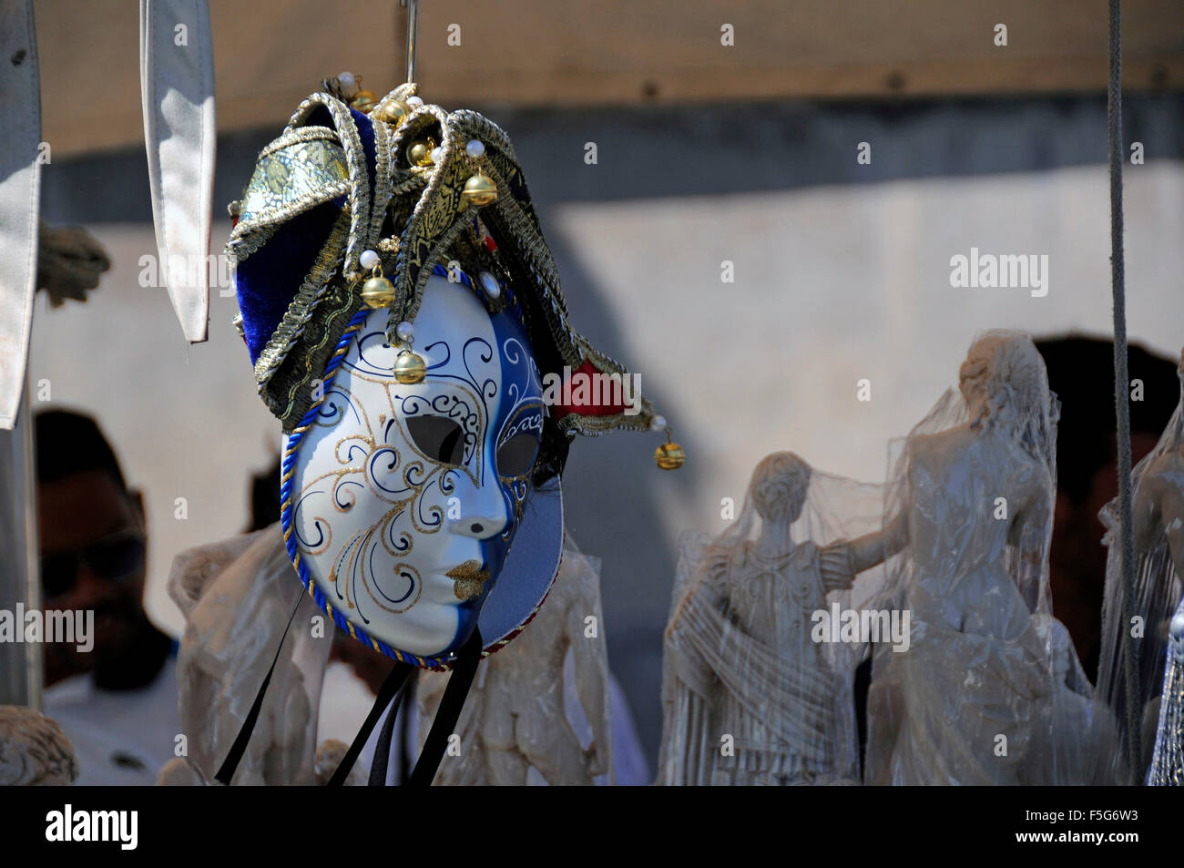 Venetian carnival face mask with bells at market stall in Rome, Italy ...