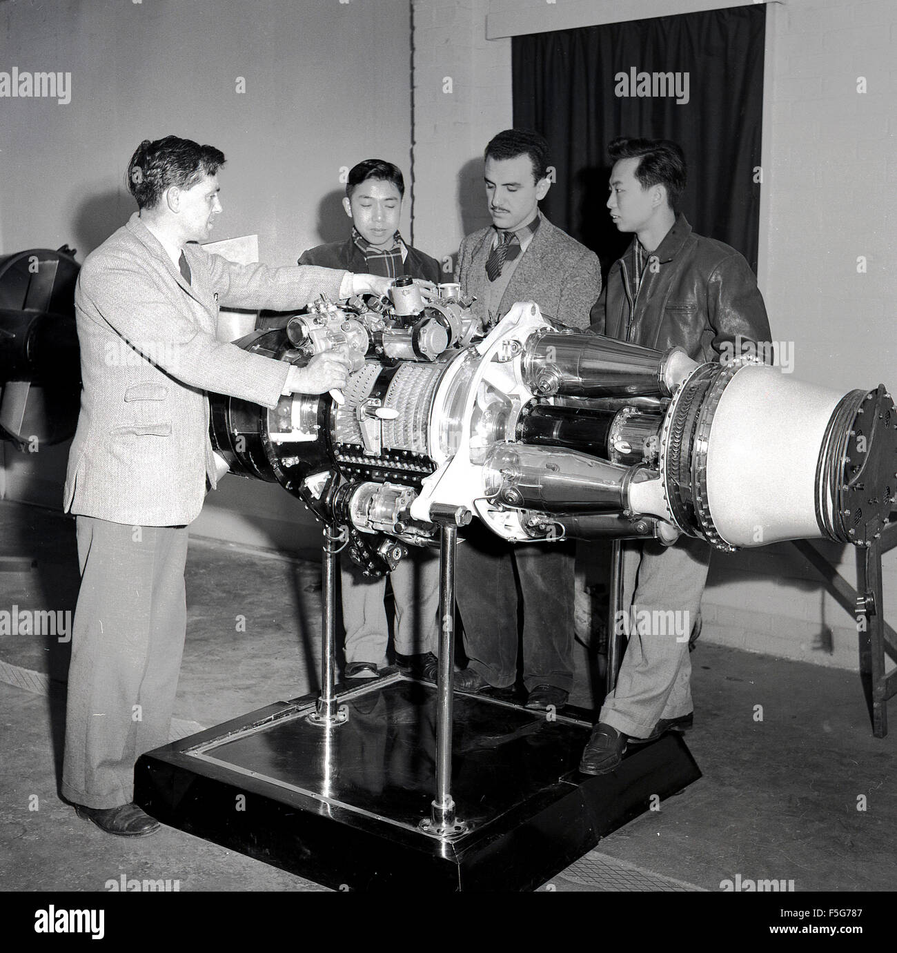 1950s historical, aircraft engineering students being shown a model of ...