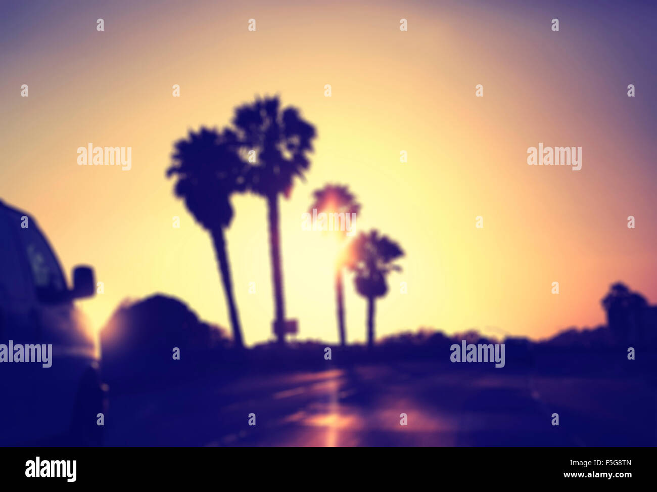 Vintage stylized blurred picture of road against sunset, travel ...