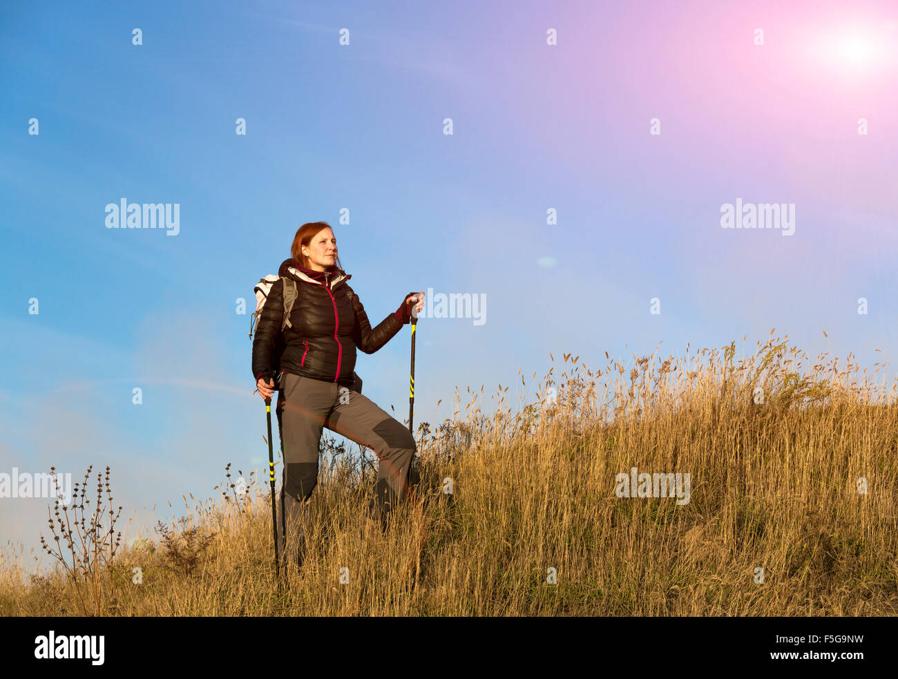 Woman walking on grassy path hi-res stock photography and images - Alamy