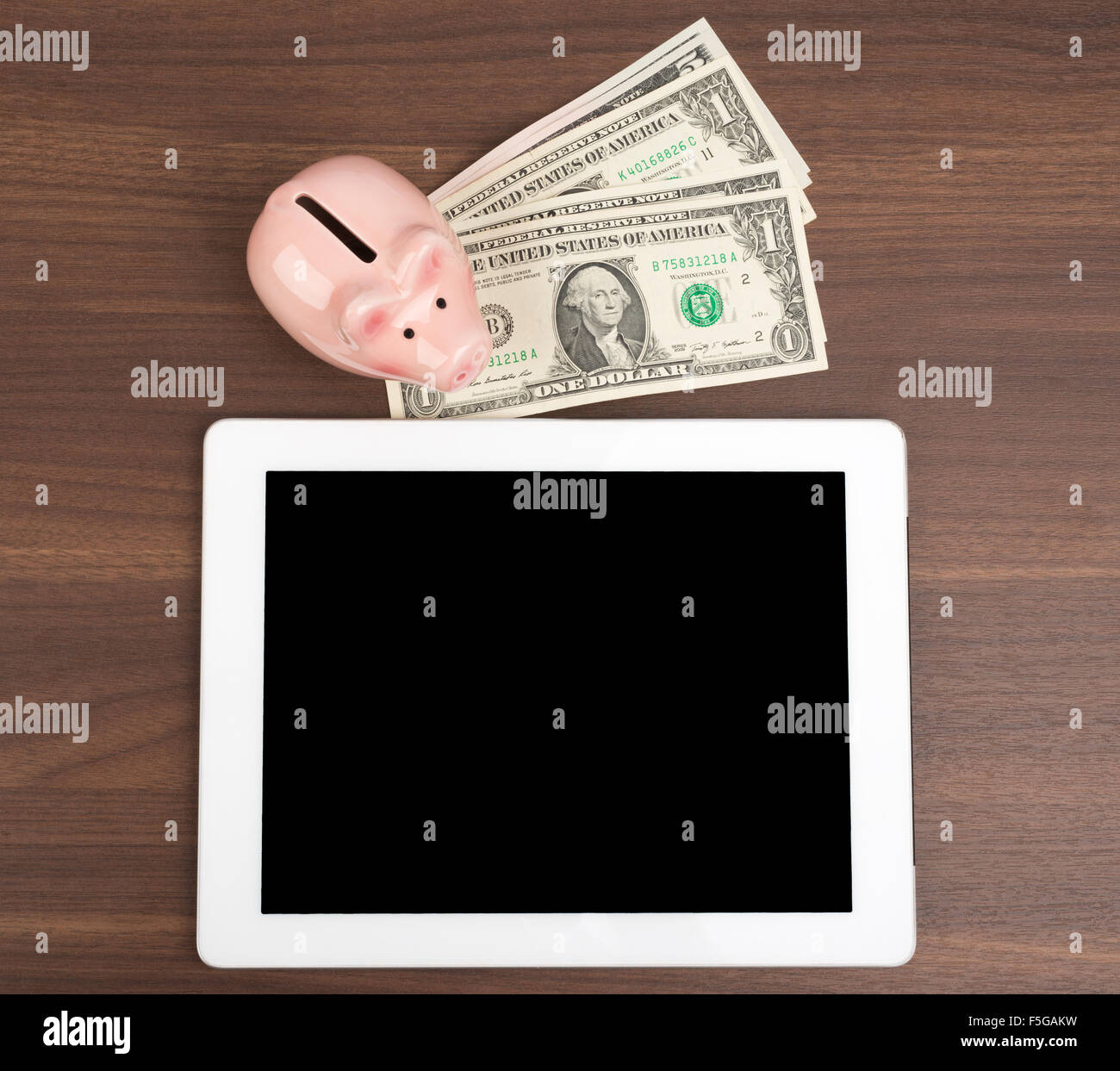 Tablet with piggy bank Stock Photo - Alamy