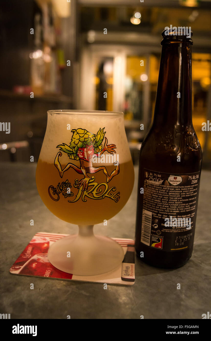 A bottle of Cuveé des Trolls Belgian craft beer in its branded glass on ...