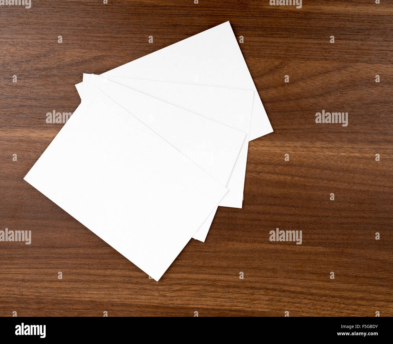Four empty cards on wood table Stock Photo - Alamy