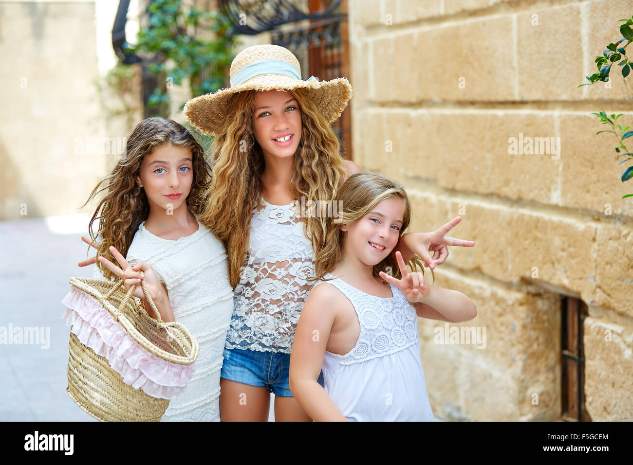 Tourist kid girls group in mediterranean white old town of Spain Stock ...