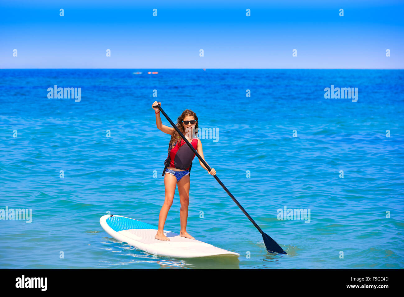 Girl paddle board standing hi-res stock photography and images - Alamy