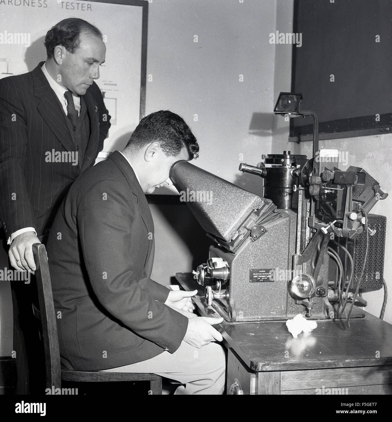historical, 1950s, industry, man using an industrial microscope Stock ...