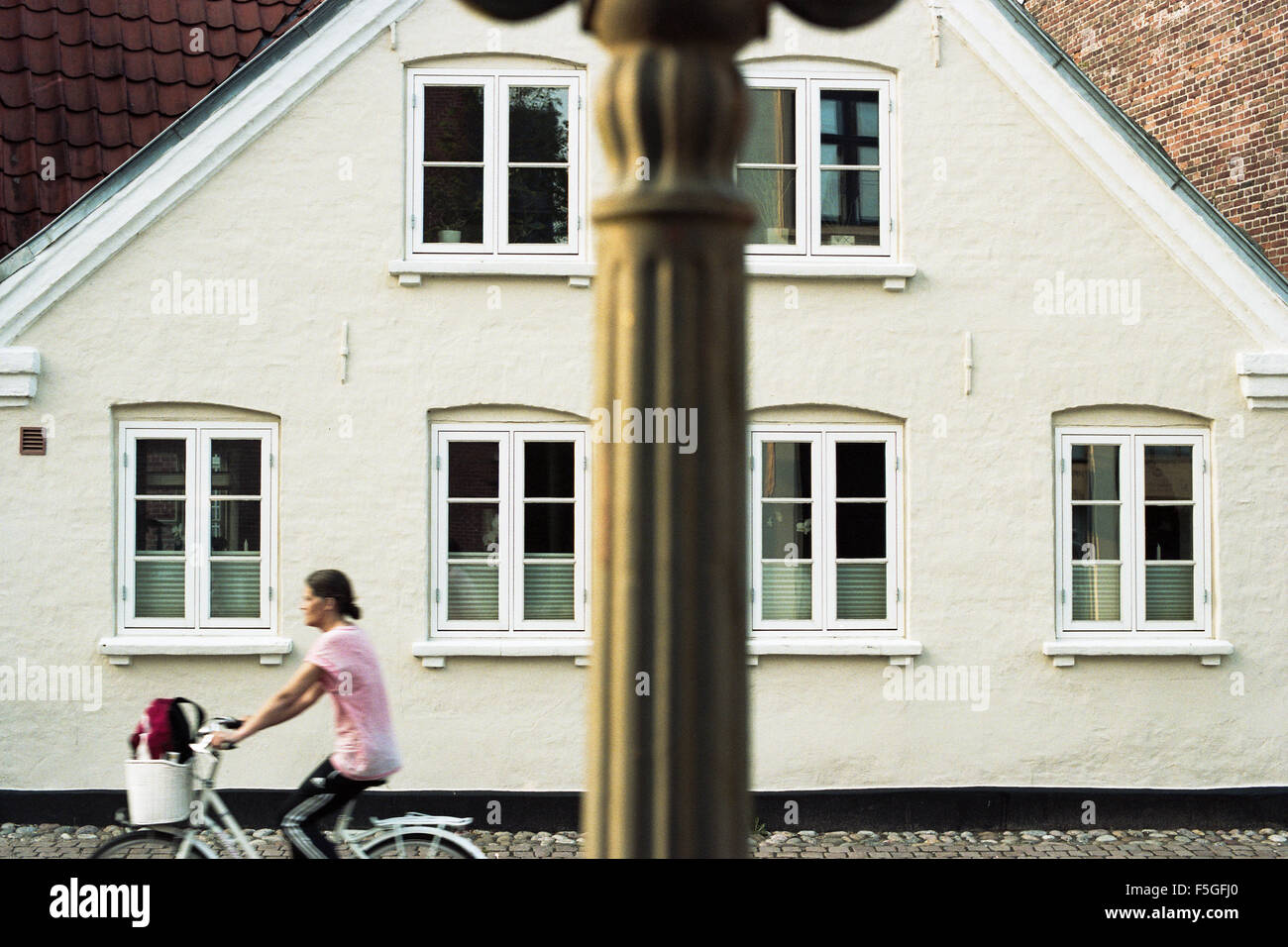 Girl riding a bike, Ribe. Denmark Stock Photo - Alamy