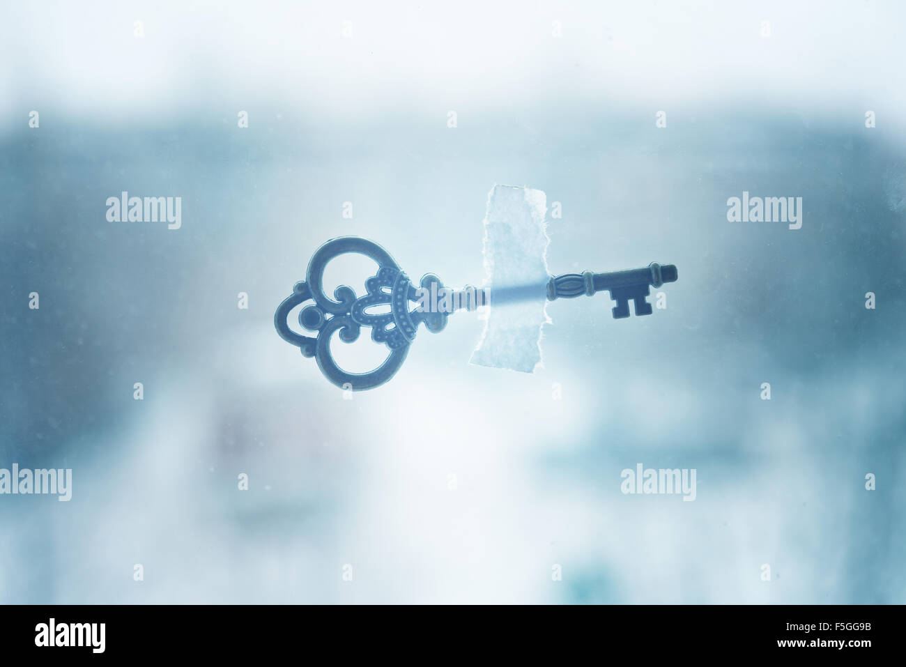 vintage key attached to window Stock Photo - Alamy