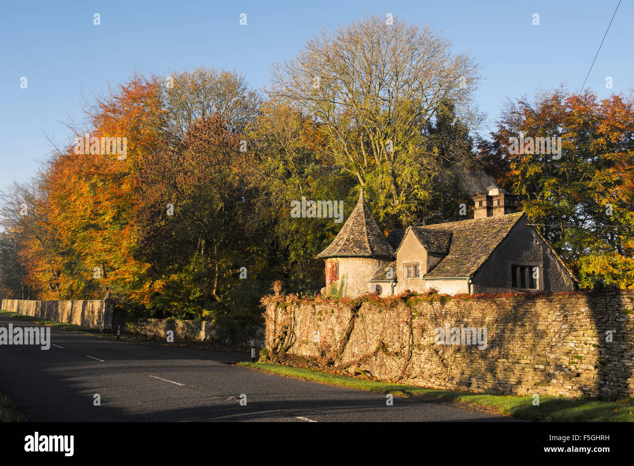Stowell park estate gate house and beech trees with autumn foilage in ...