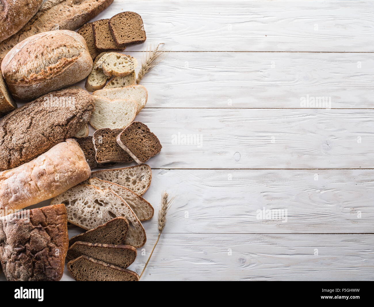 Different types of bread arranged as a frame on left side Stock Photo ...