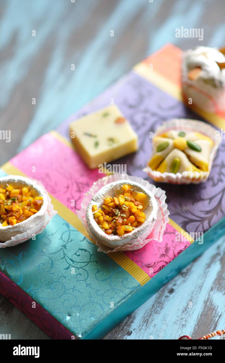 Indian sweets on a blue background Stock Photo - Alamy