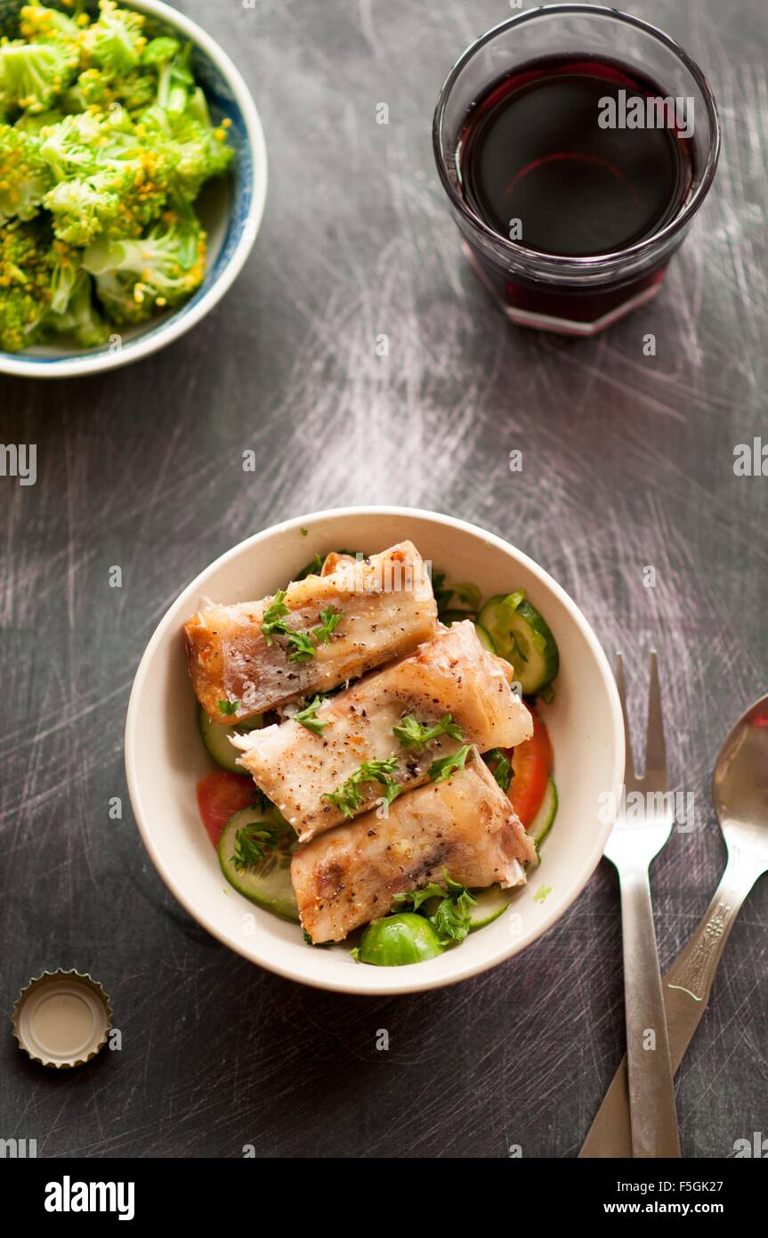 Baked fish served with wine and broccoli Stock Photo - Alamy