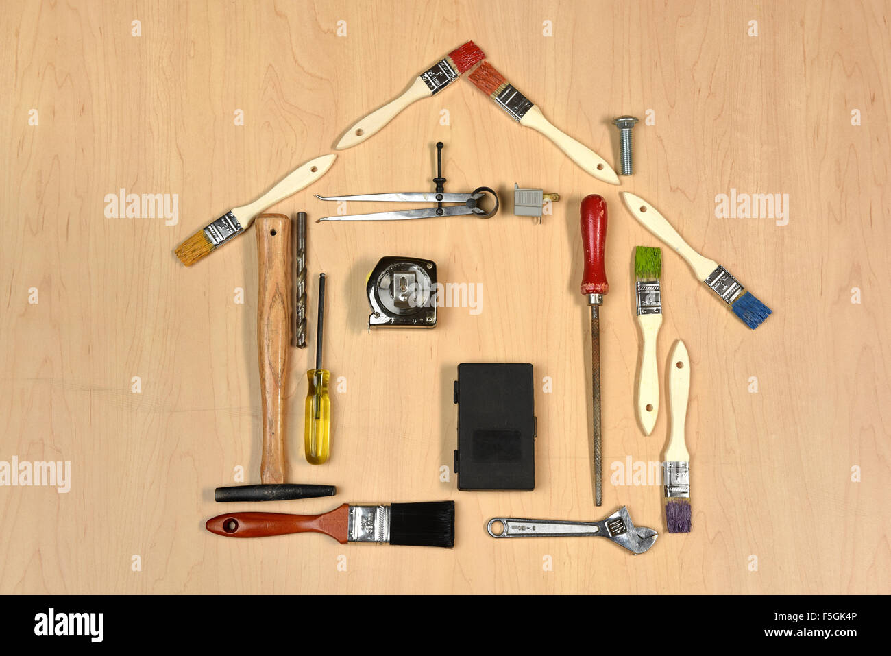 House made out of tools over wooden surface Stock Photo - Alamy