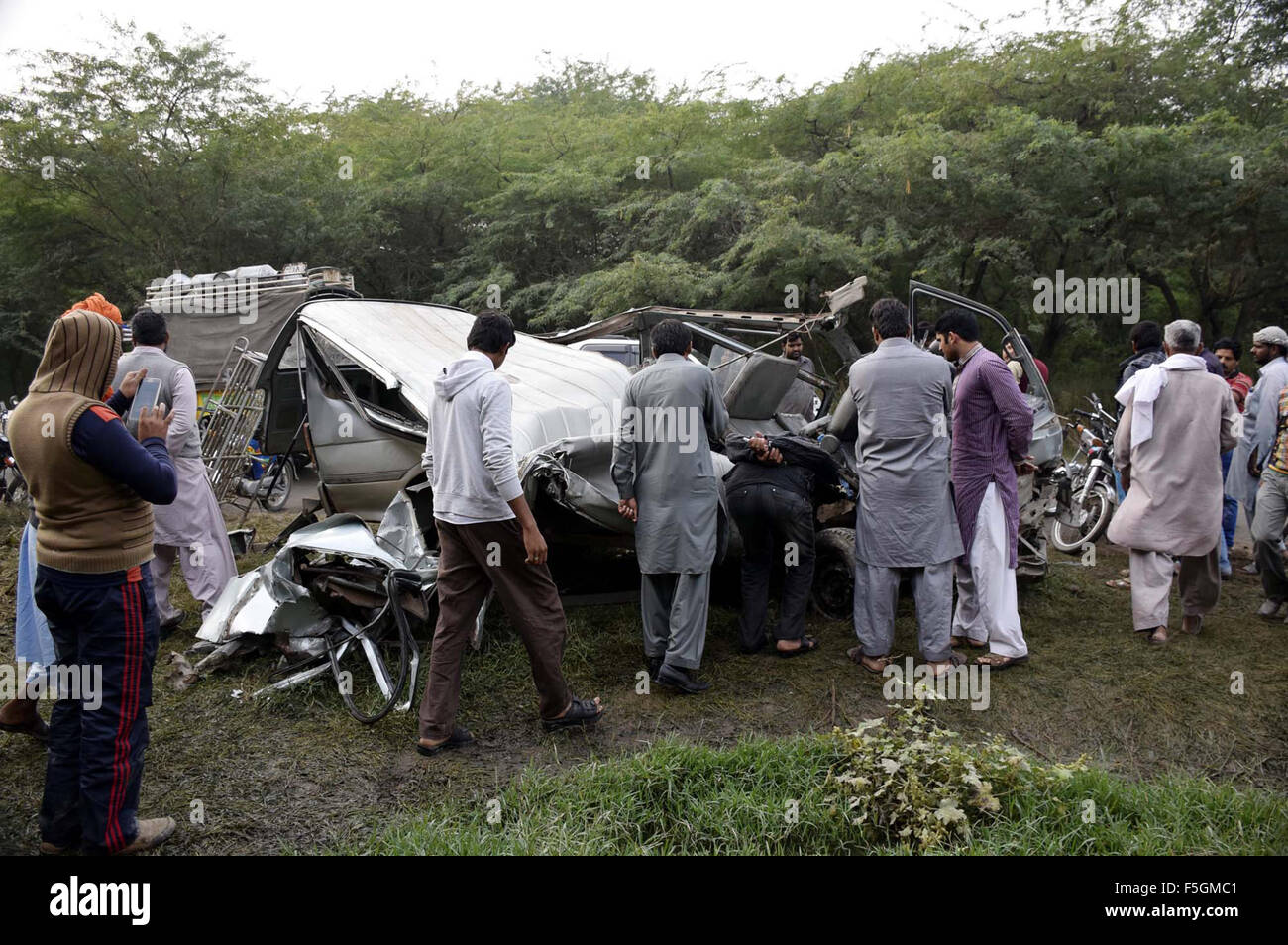 People look the wreckage of Toyota passenger van after a after traffic ...