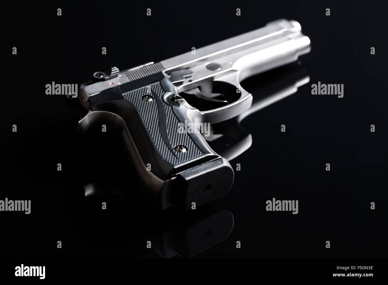the handgun on black background Stock Photo - Alamy