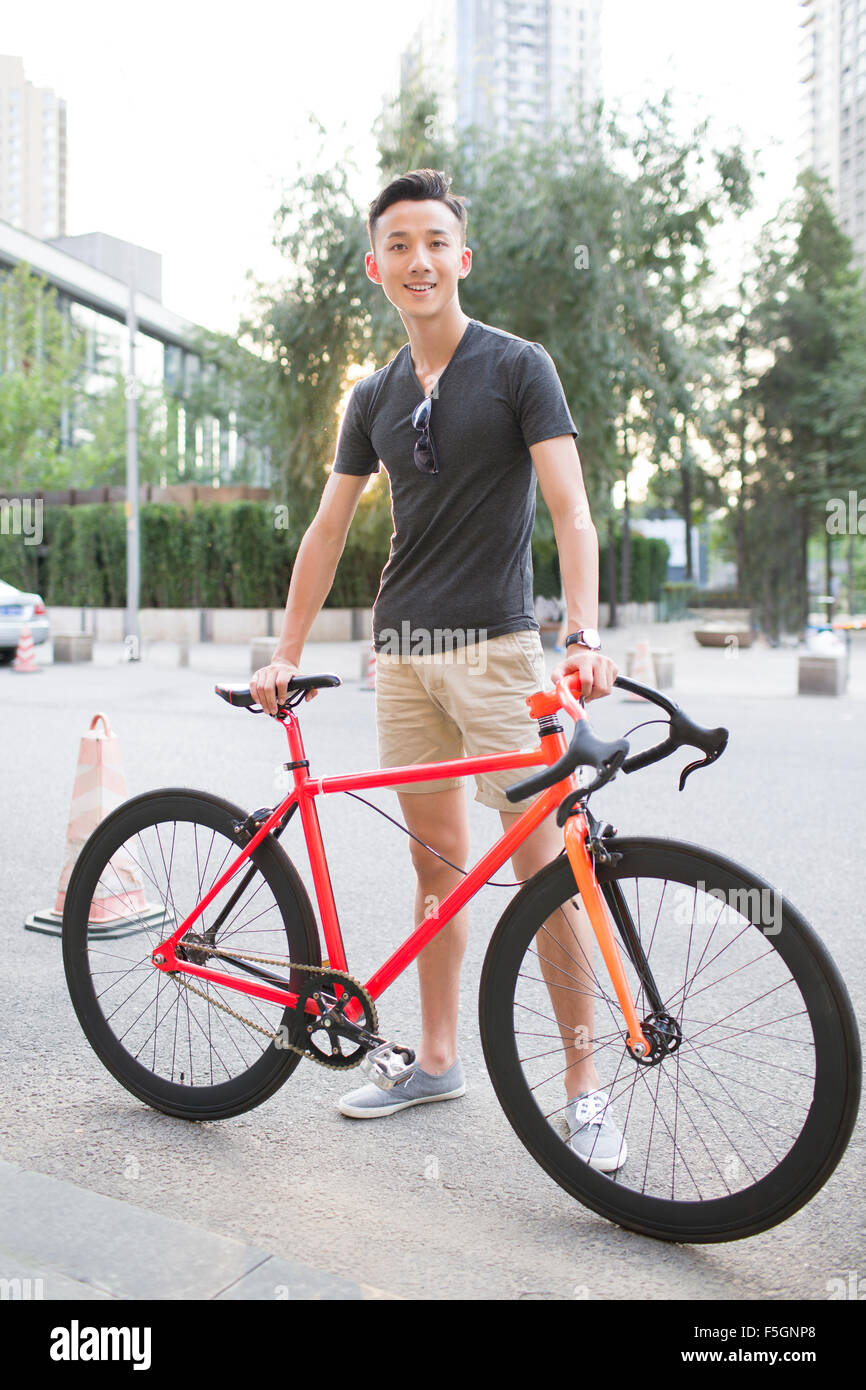 Happy young man and bicycle Stock Photo - Alamy